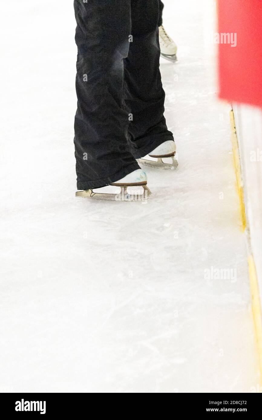 View of a figure skater and her coach feet at the figure skating ...