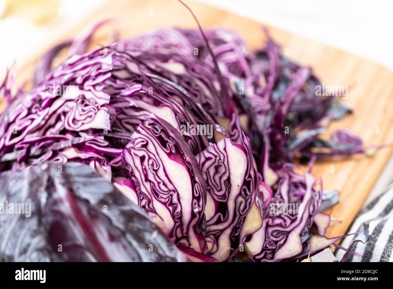 Shredding red cabbage on a wood cutting board Stock Photo - Alamy