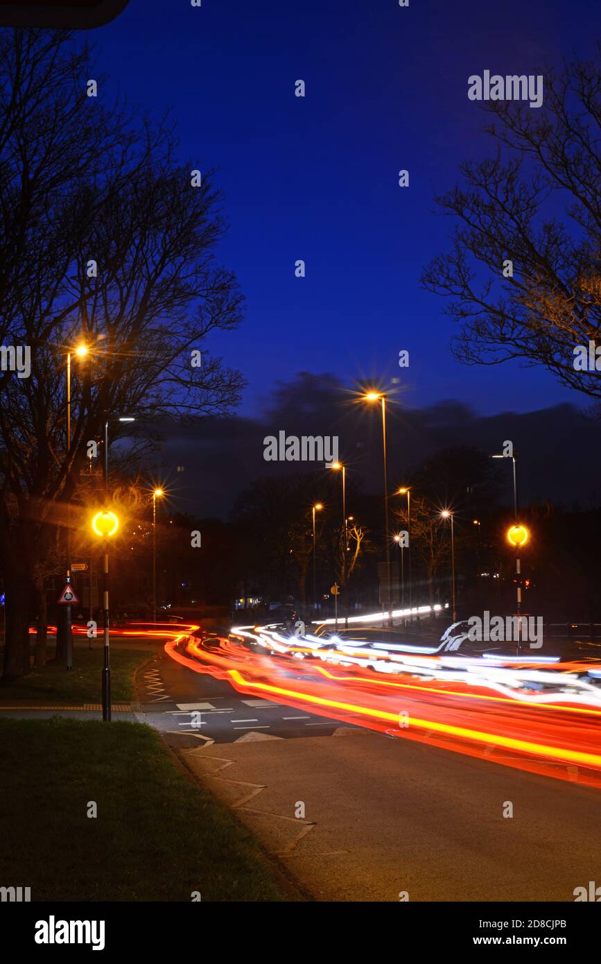 traffic passing belisha beacon flashing at zebra crossing at dusk leeds ...