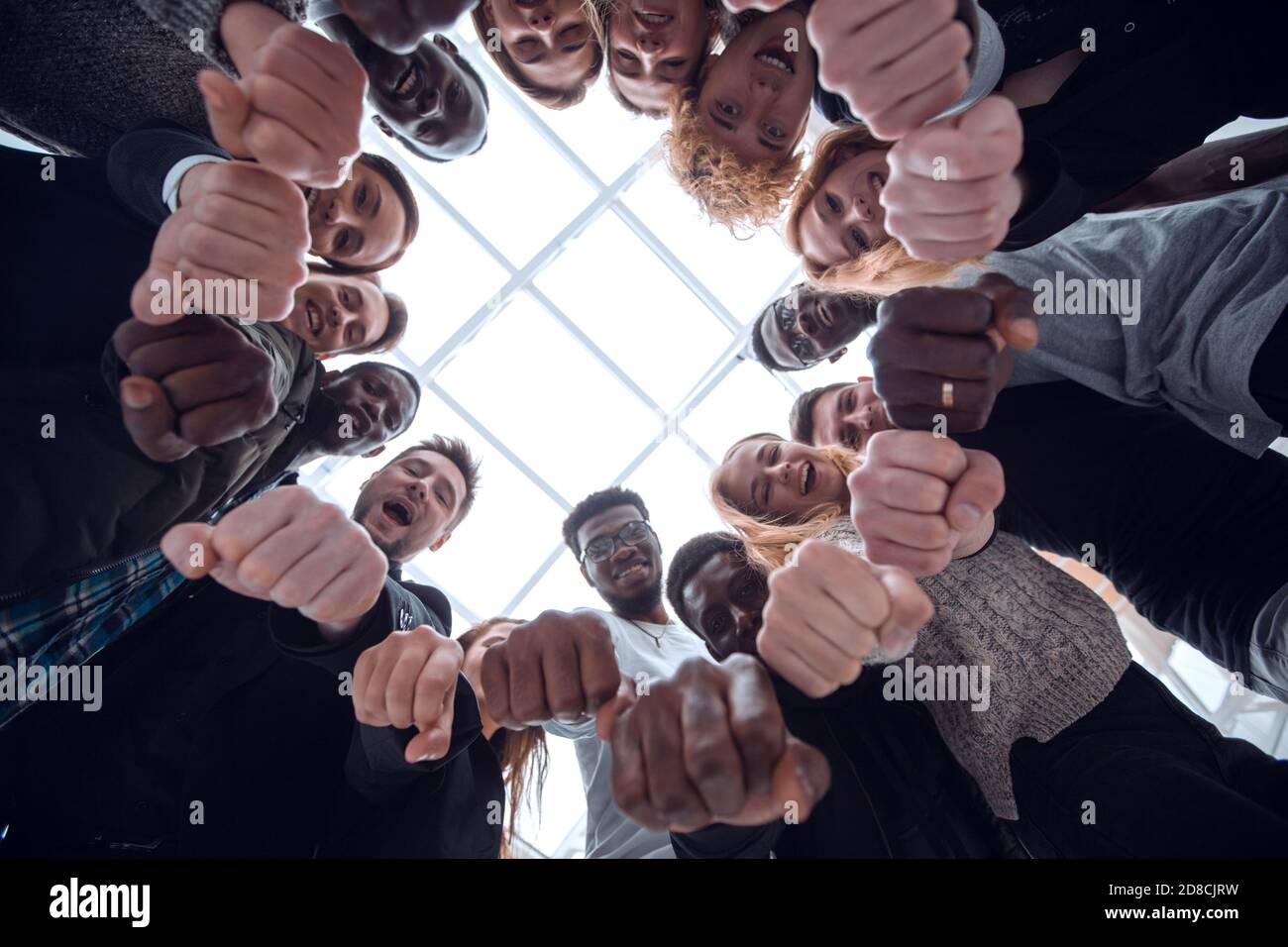 group of diverse young people joining their hands in a ring Stock Photo ...