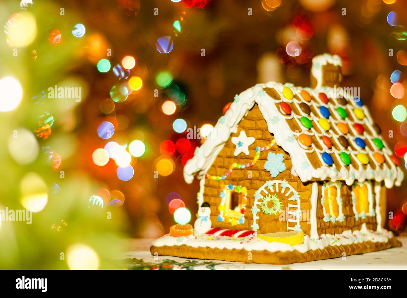gingerbread house with blurred garland lights background Stock Photo ...