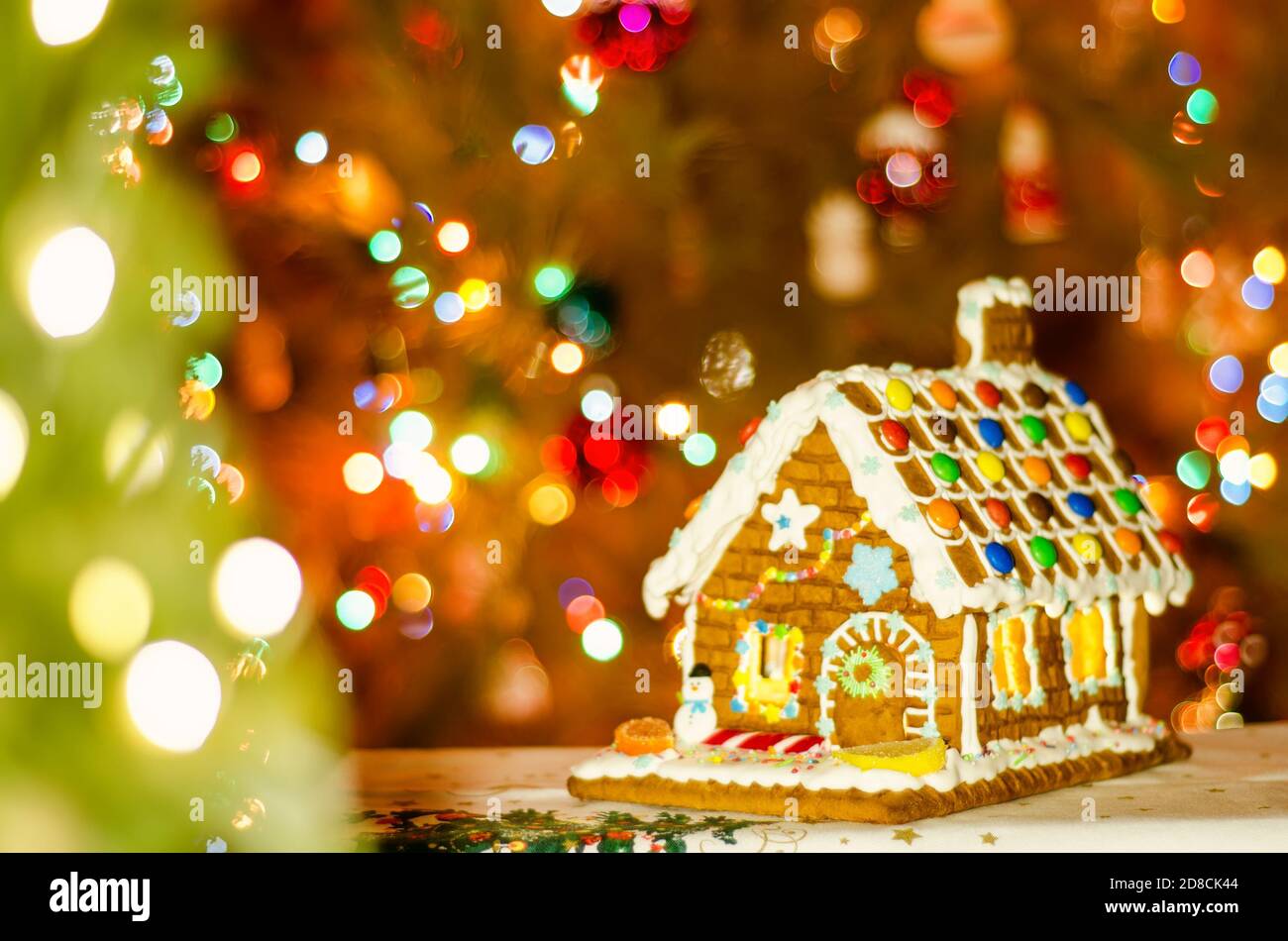 gingerbread house with blurred garland lights background Stock Photo ...