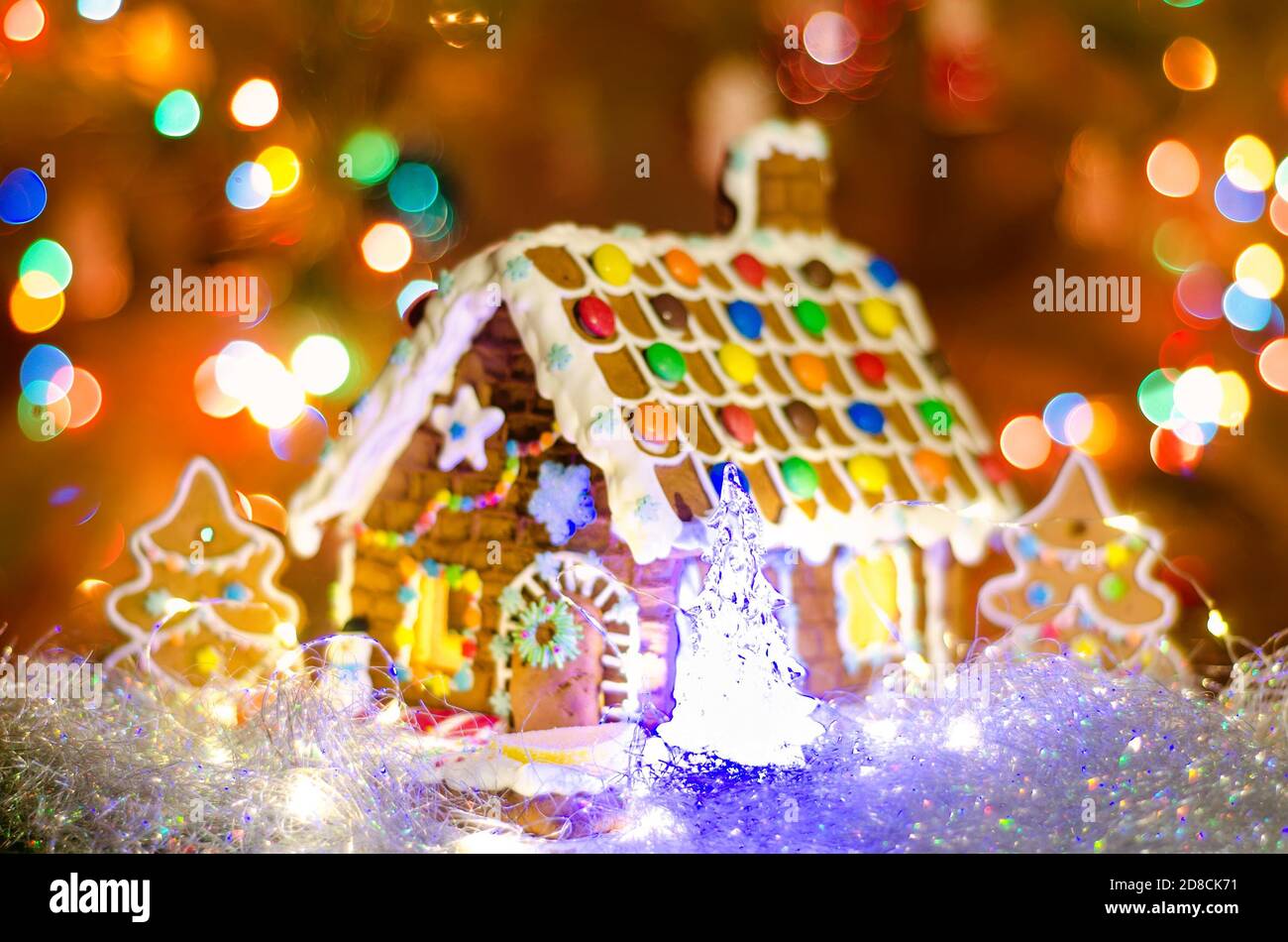 gingerbread house with blurred garland lights background Stock Photo ...