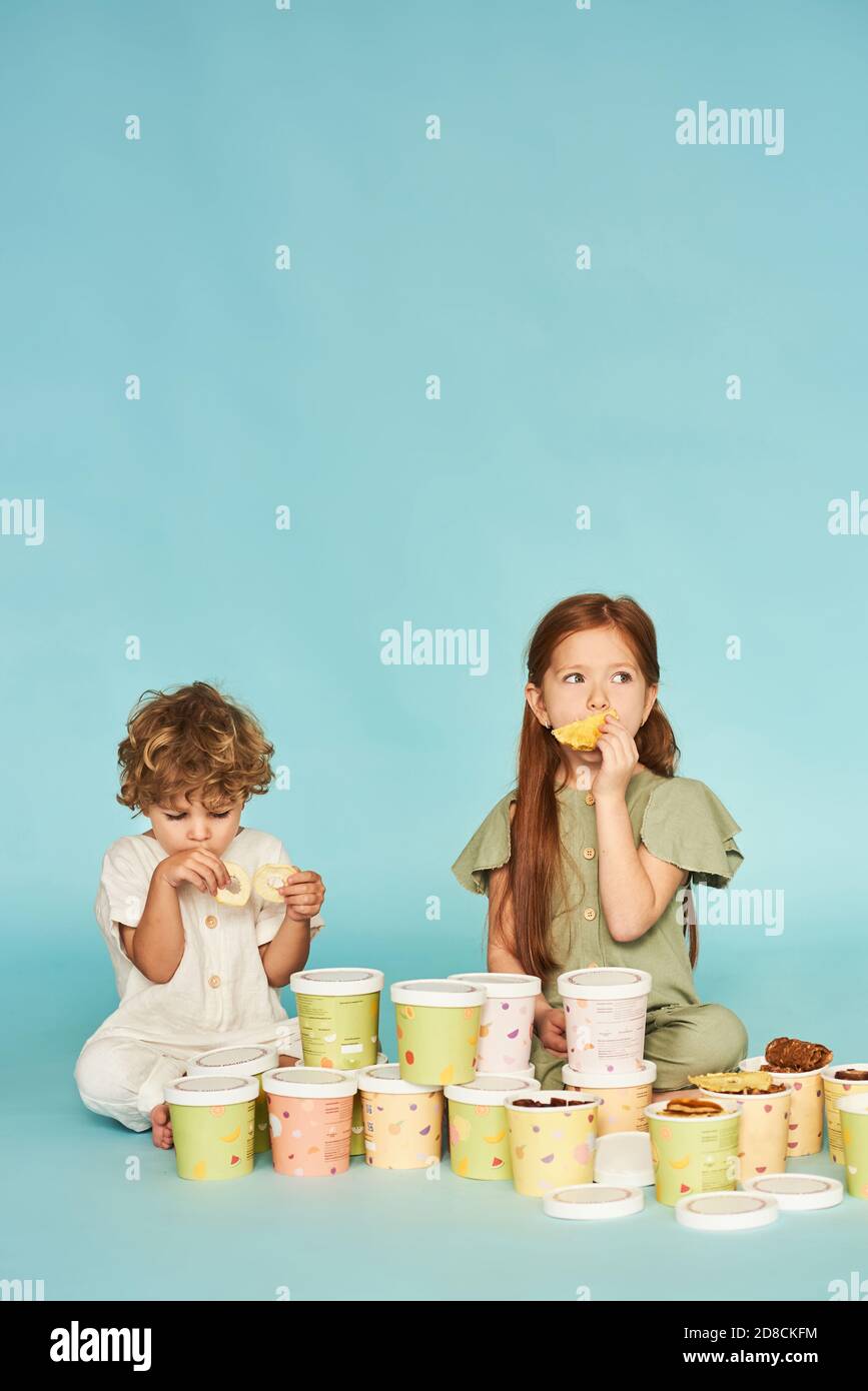 Children enjoy different types of pastilles on a blue background ...