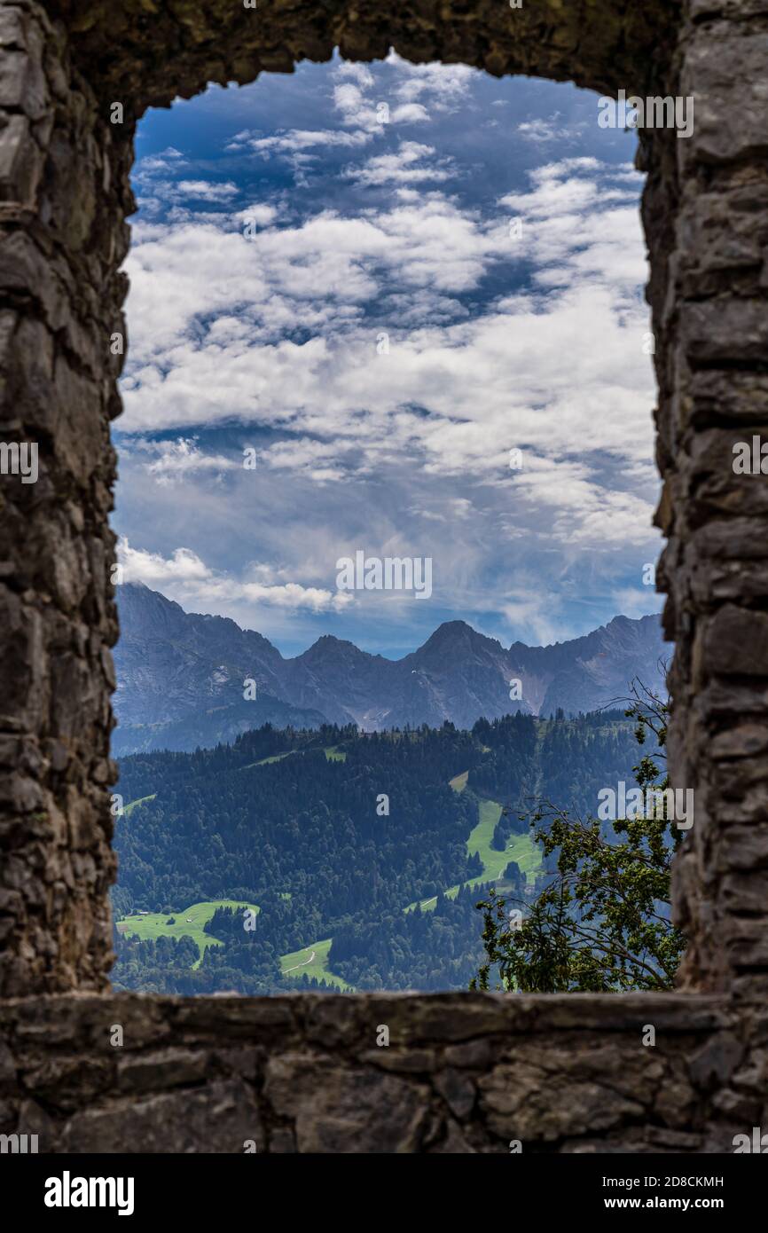 Mountain view through a window of the karwendel mountains with clouds ...