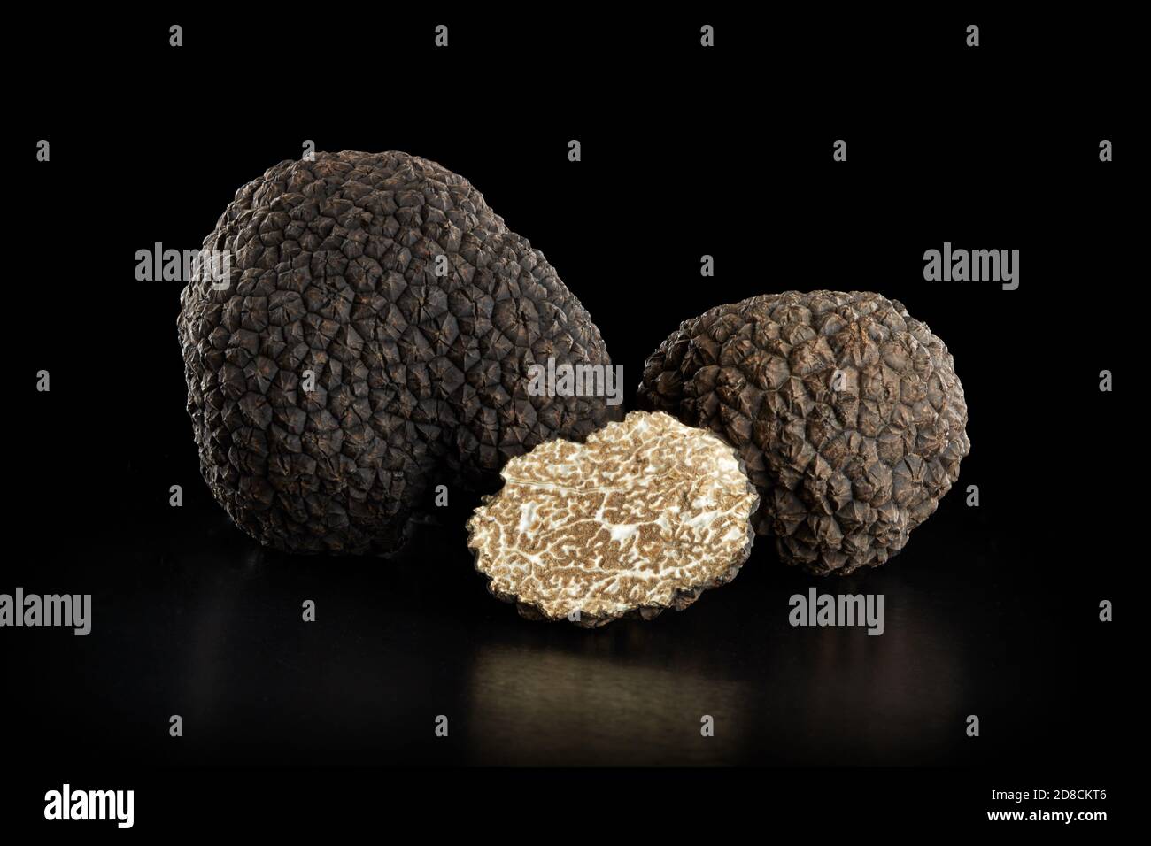 Black truffles group and slice on black, clipping path included Stock ...