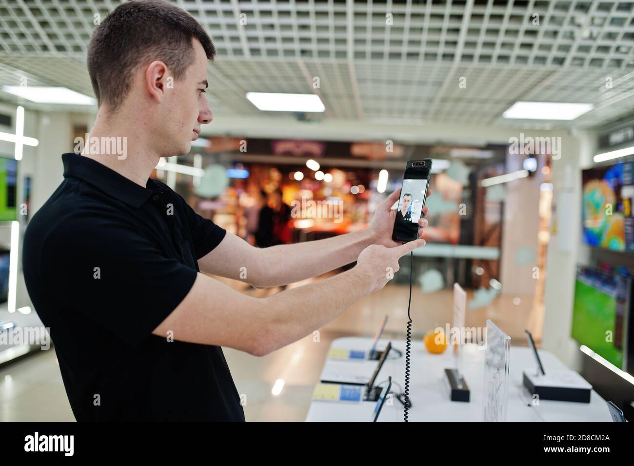 Seller man mobile phone professional consultant in tech store or shop ...