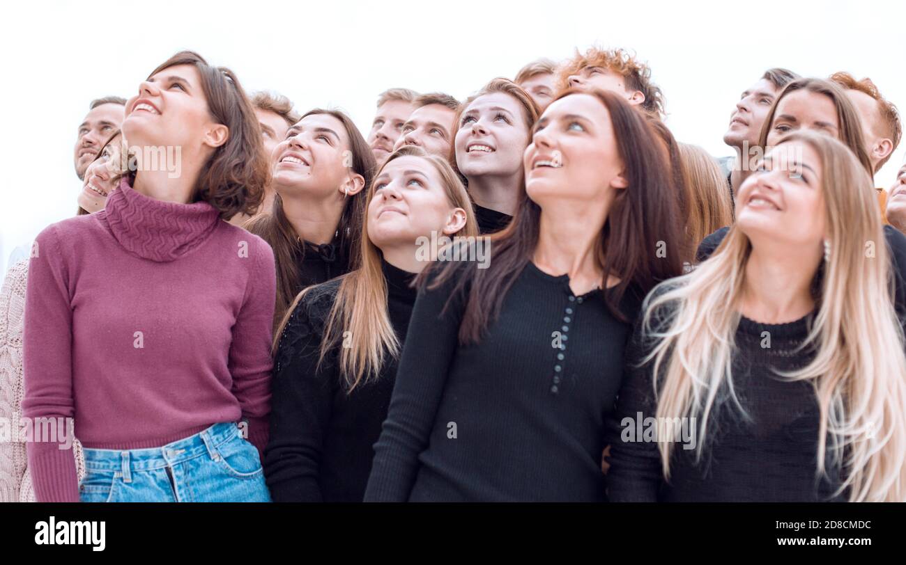 close up. happy young people looking up somewhere Stock Photo - Alamy