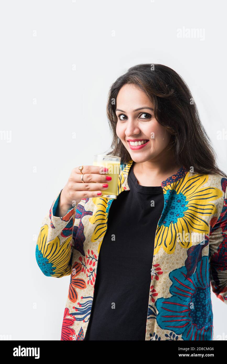 Pretty Asian Indian Young Woman Holding Or Drinking Turmeric Milk In A