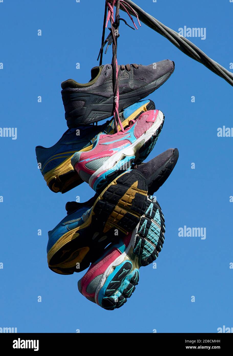 some shoes on a electric cable Stock Photo - Alamy