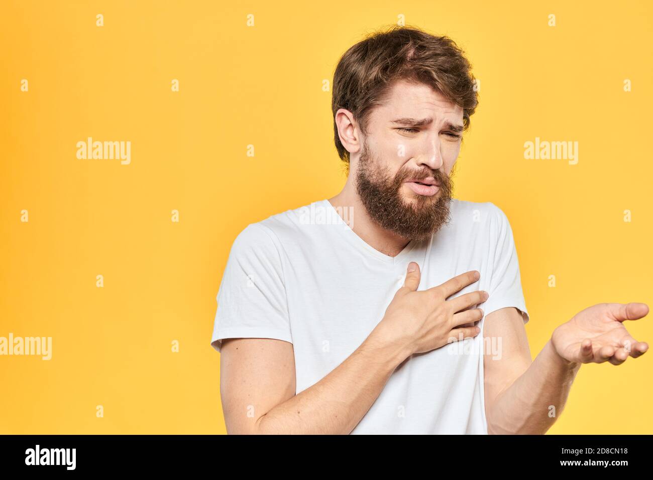 Man in white t-shirt emotions studio gestures with hands displeased ...