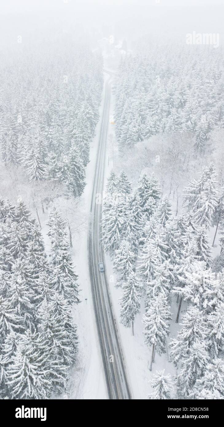 Road through Snow Covered White Forest in Deep Winter Storm with Car on ...