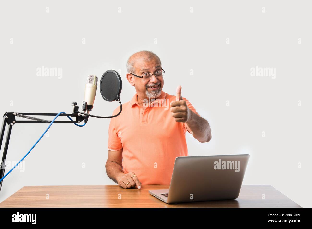 Confident Indian old man speaking in recording mic with filter while ...