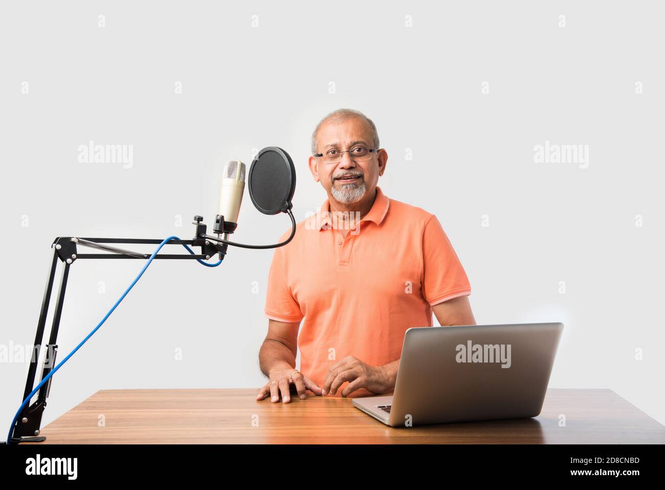 Confident Indian old man speaking in recording mic with filter while ...