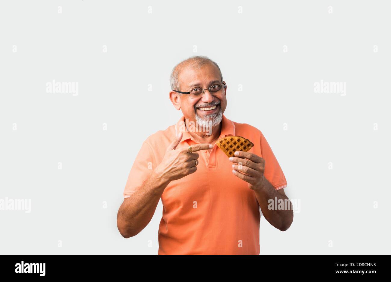 Indian man eating sweet hi-res stock photography and images - Alamy
