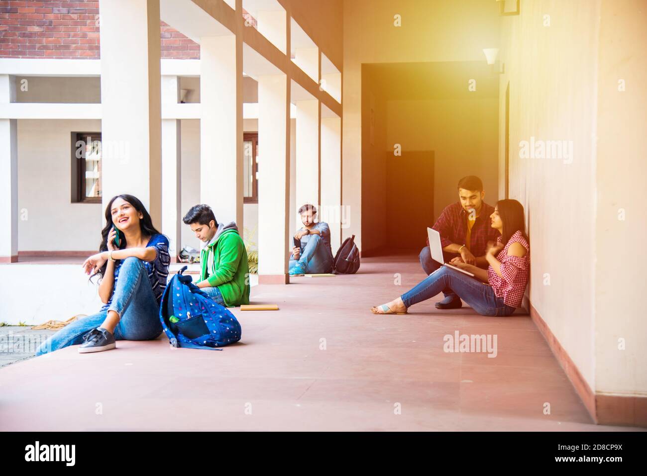 Asian Indian college students using smartphone while sitting in college ...