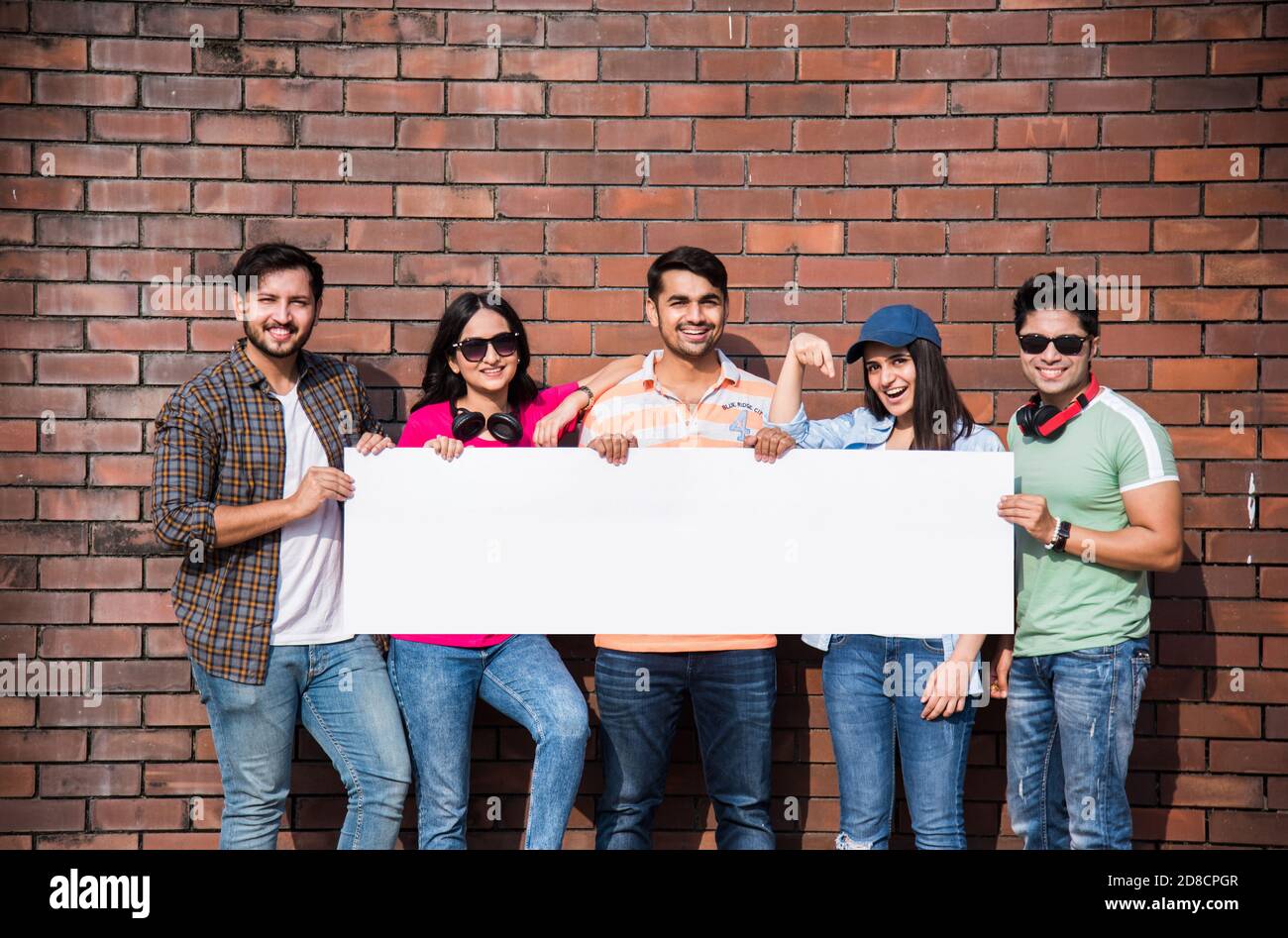 Asian Indian college students Holding or showing empty white board or ...