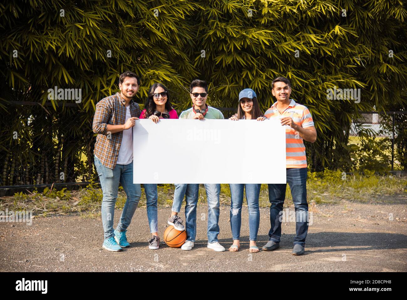 Asian Indian college students Holding or showing empty white board or ...