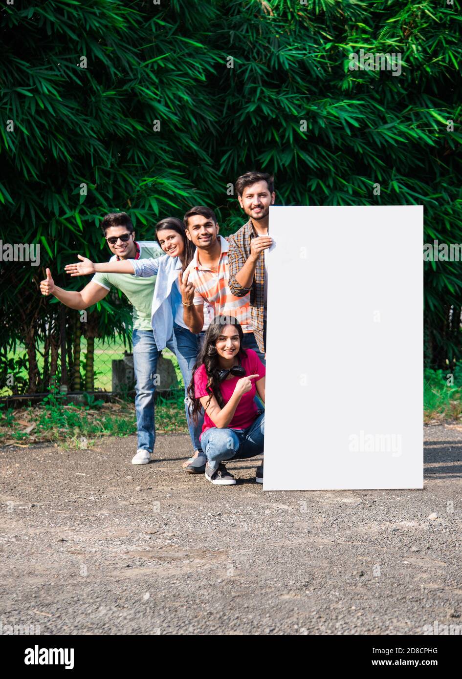 Asian Indian college students Holding or showing empty white board or ...