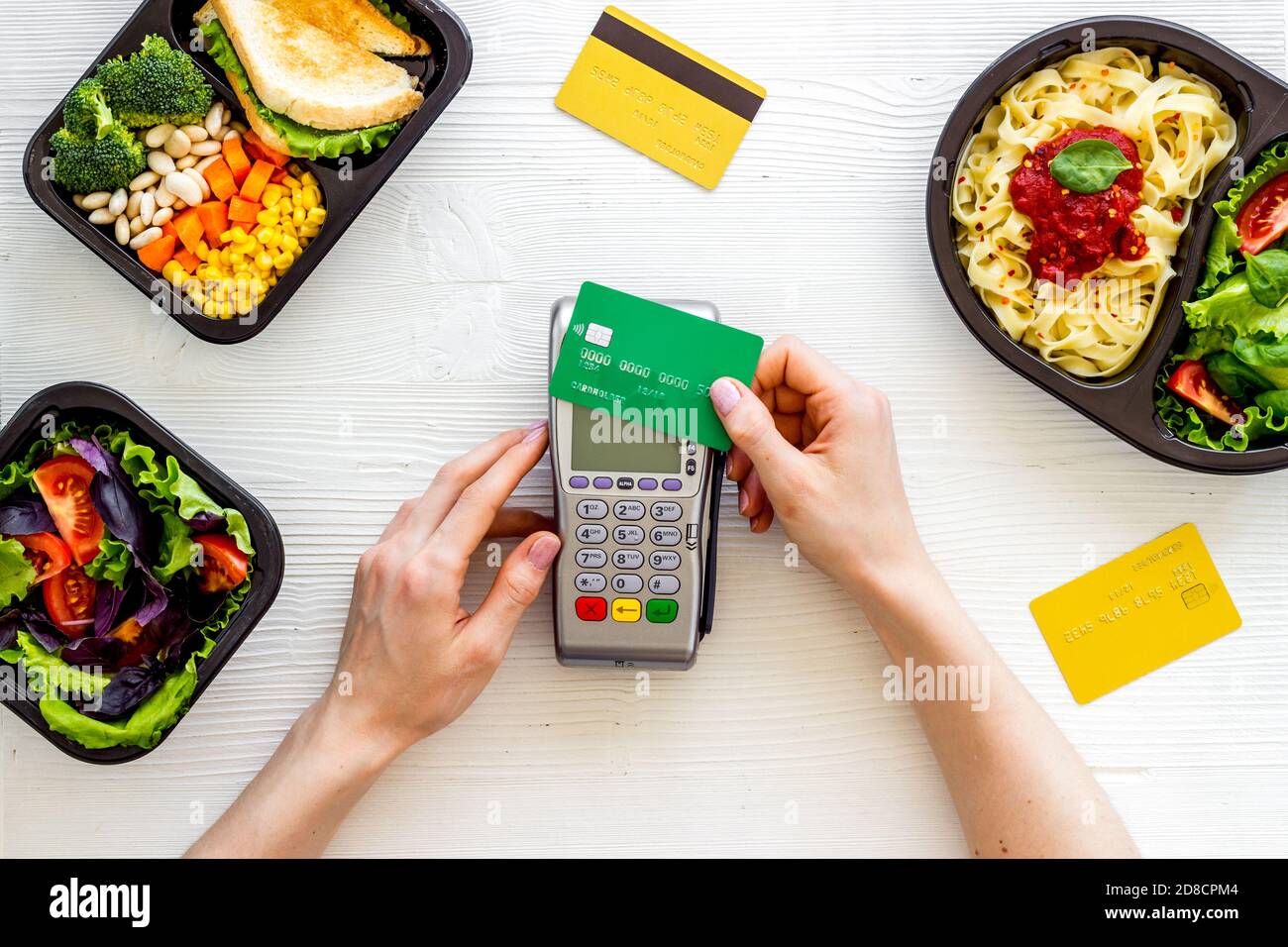 Hands with credit card and payment terminal. Restaurant food delivery ...
