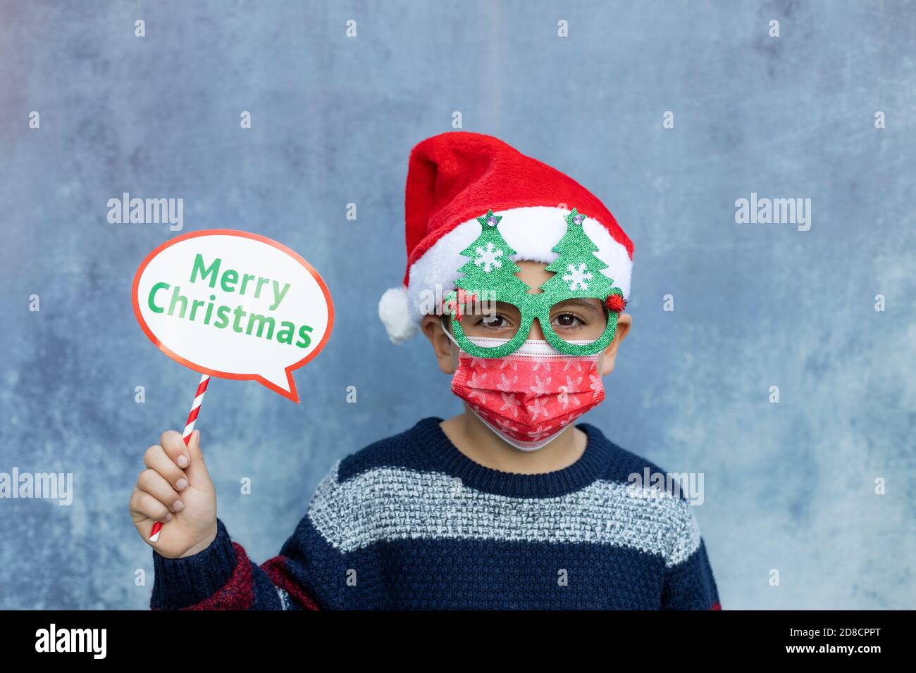 Little kid with face mask on Christmas Stock Photo - Alamy