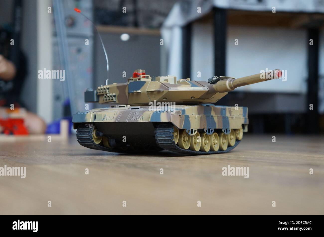 Plastic tank toy on the floor Stock Photo - Alamy