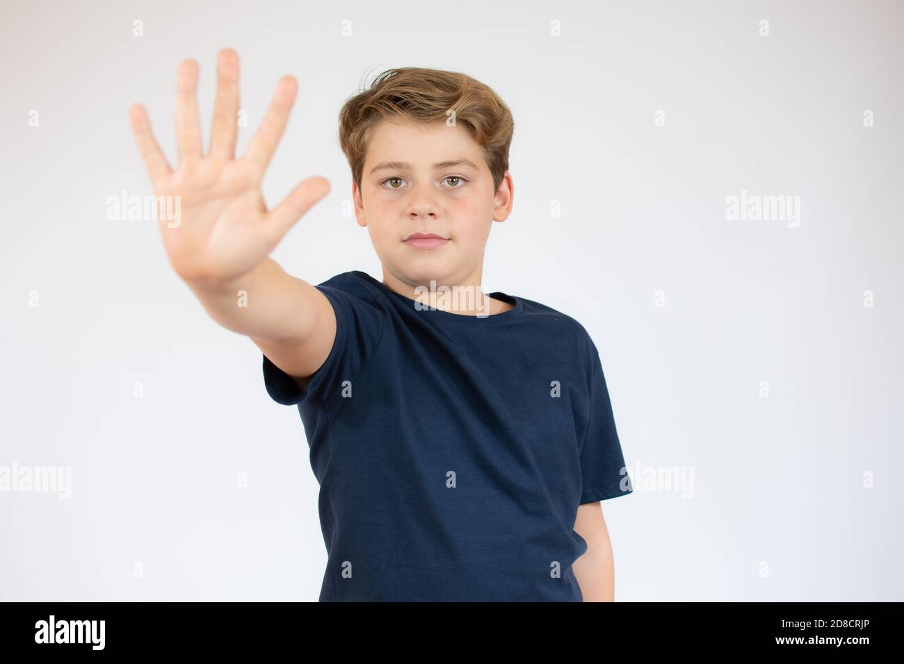 Boy making stop gesture with his palm on white background. Body ...