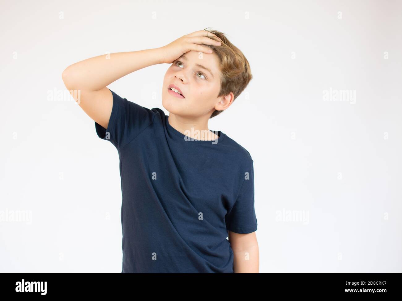 Little boy standing thinking on white background isolated, boy look up ...