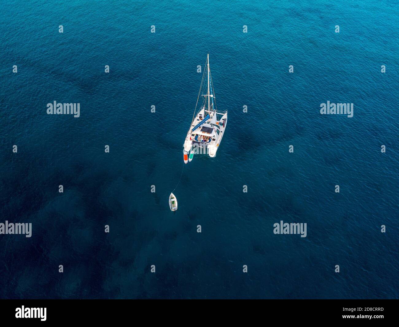 Aerial view of moored catamaran floating on a transparent sea. Scuba ...