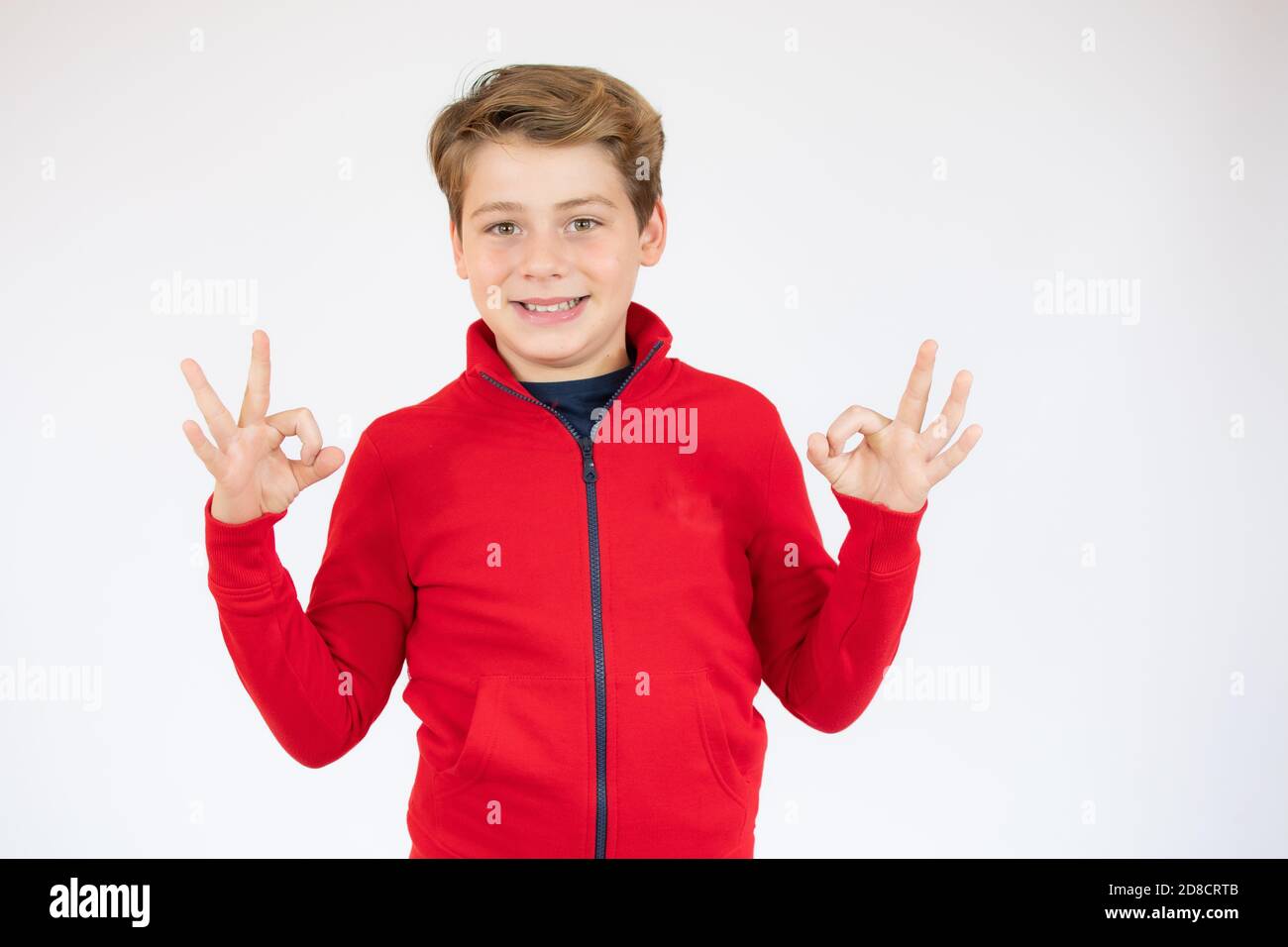 Boy showing okay gesture in sign language on white background Stock ...