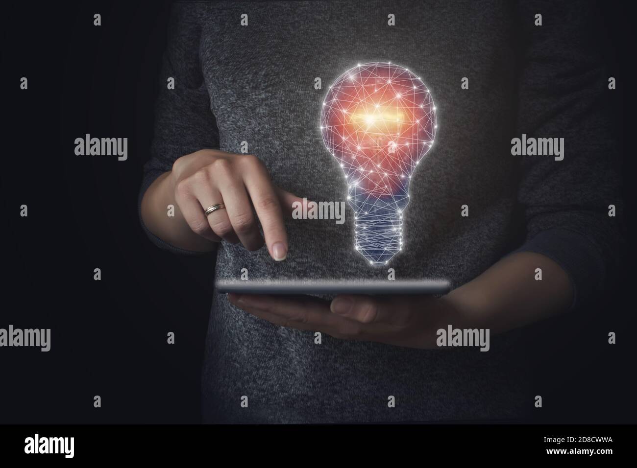 Hand holding tablet with drawing light bulb. Close up, idea concept ...