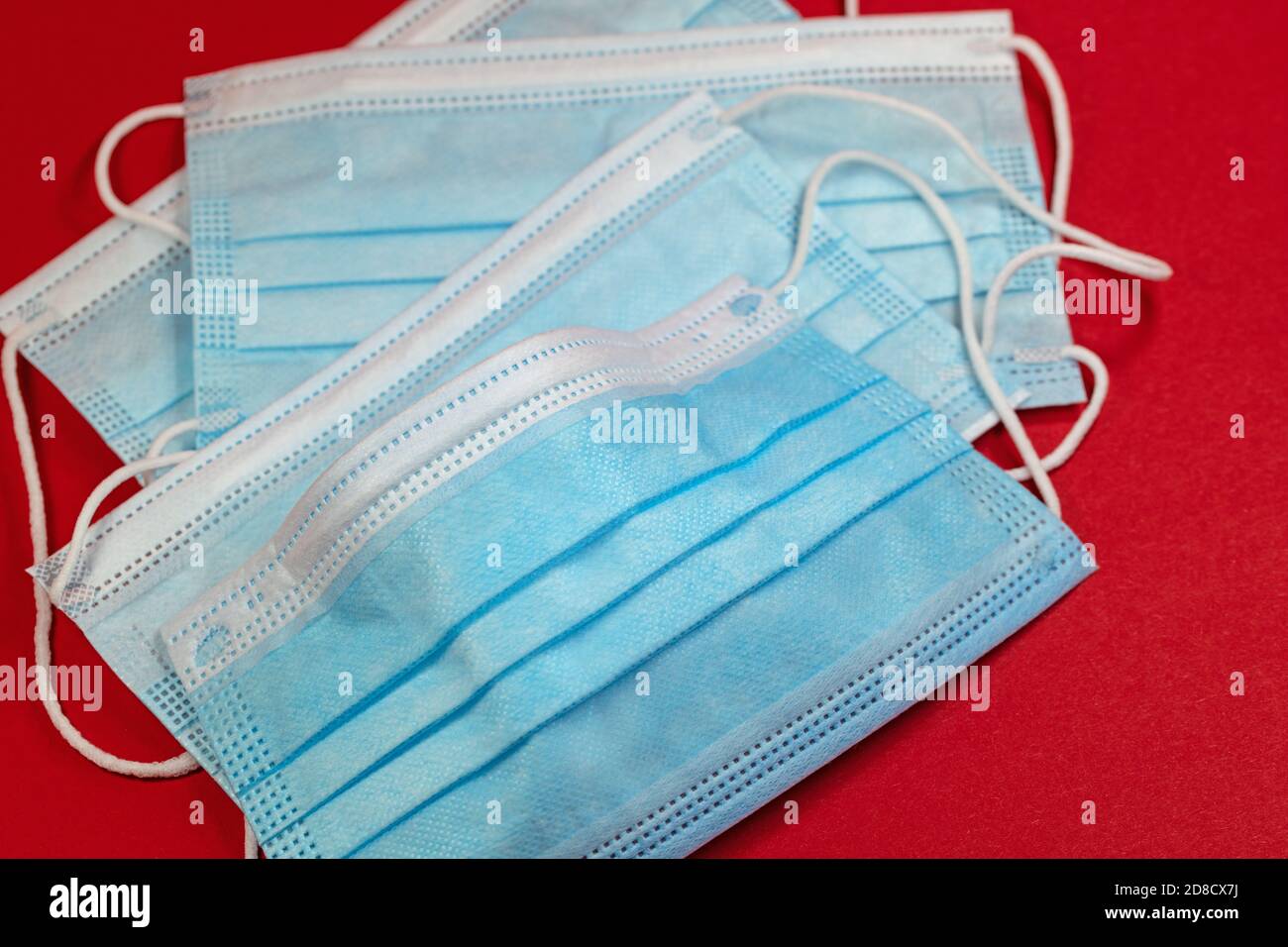 Disposable breathing masks isolated against a red background Stock ...
