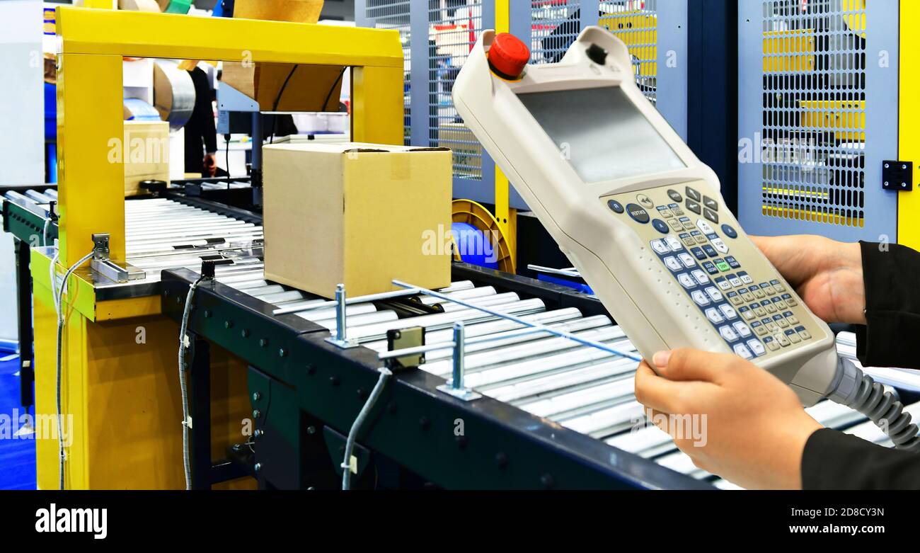Manager check and control automation cardboard boxes on conveyor belt ...