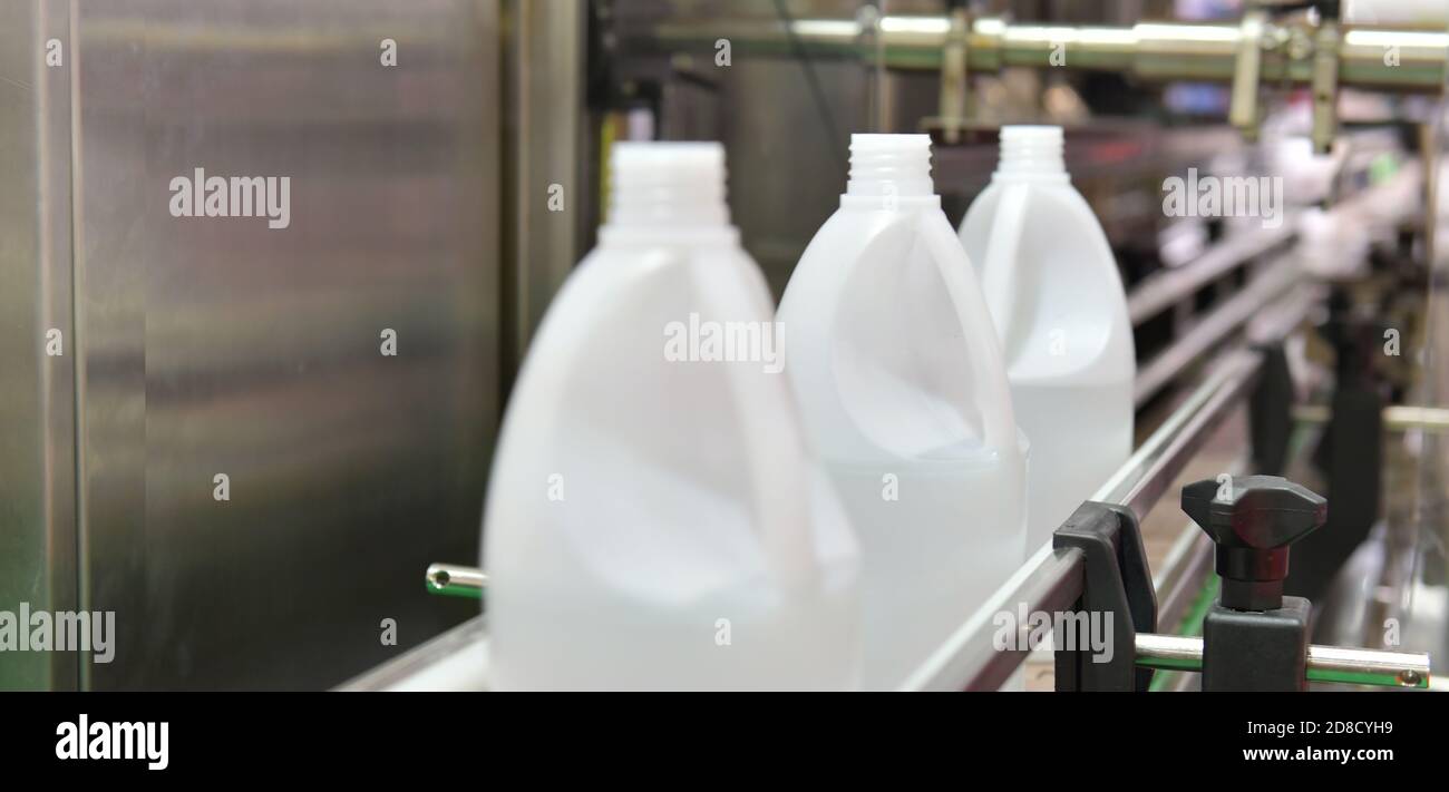 White plastic Bottles transfer on Automated conveyor systems industrial ...