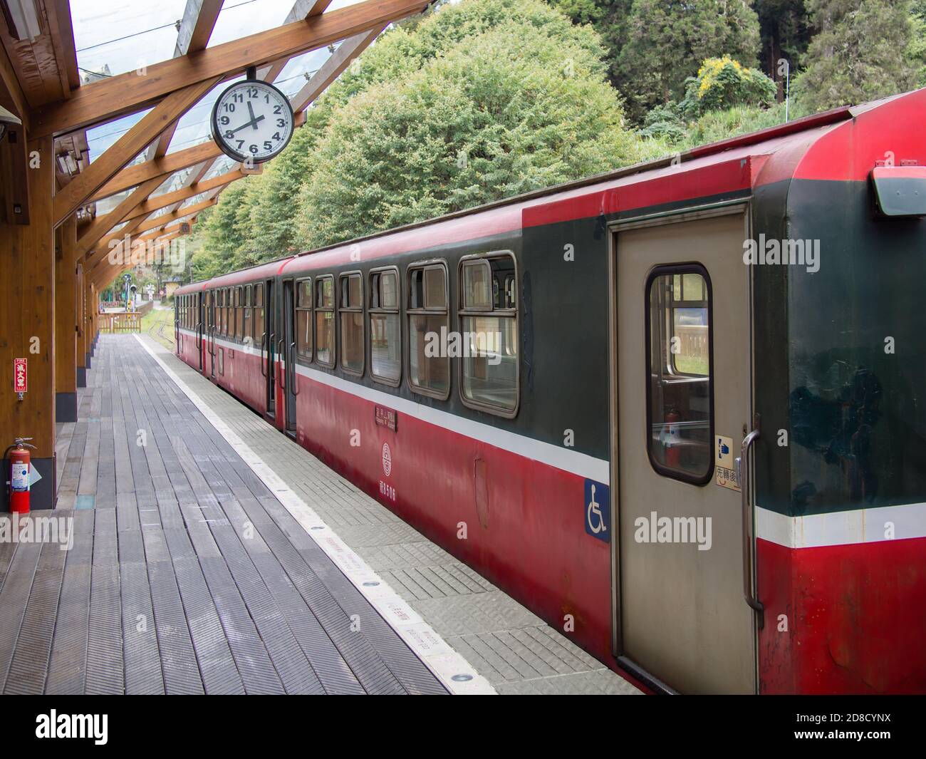 A red train stopped at the Zhaoping Station on Alishan in Chiayi ...