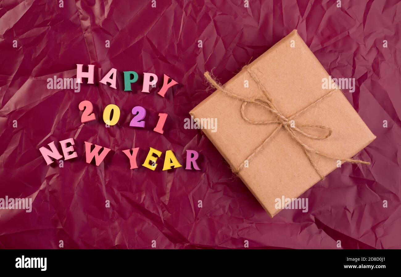 Happy New Year greeting words made of wooden letters, on a purple ...