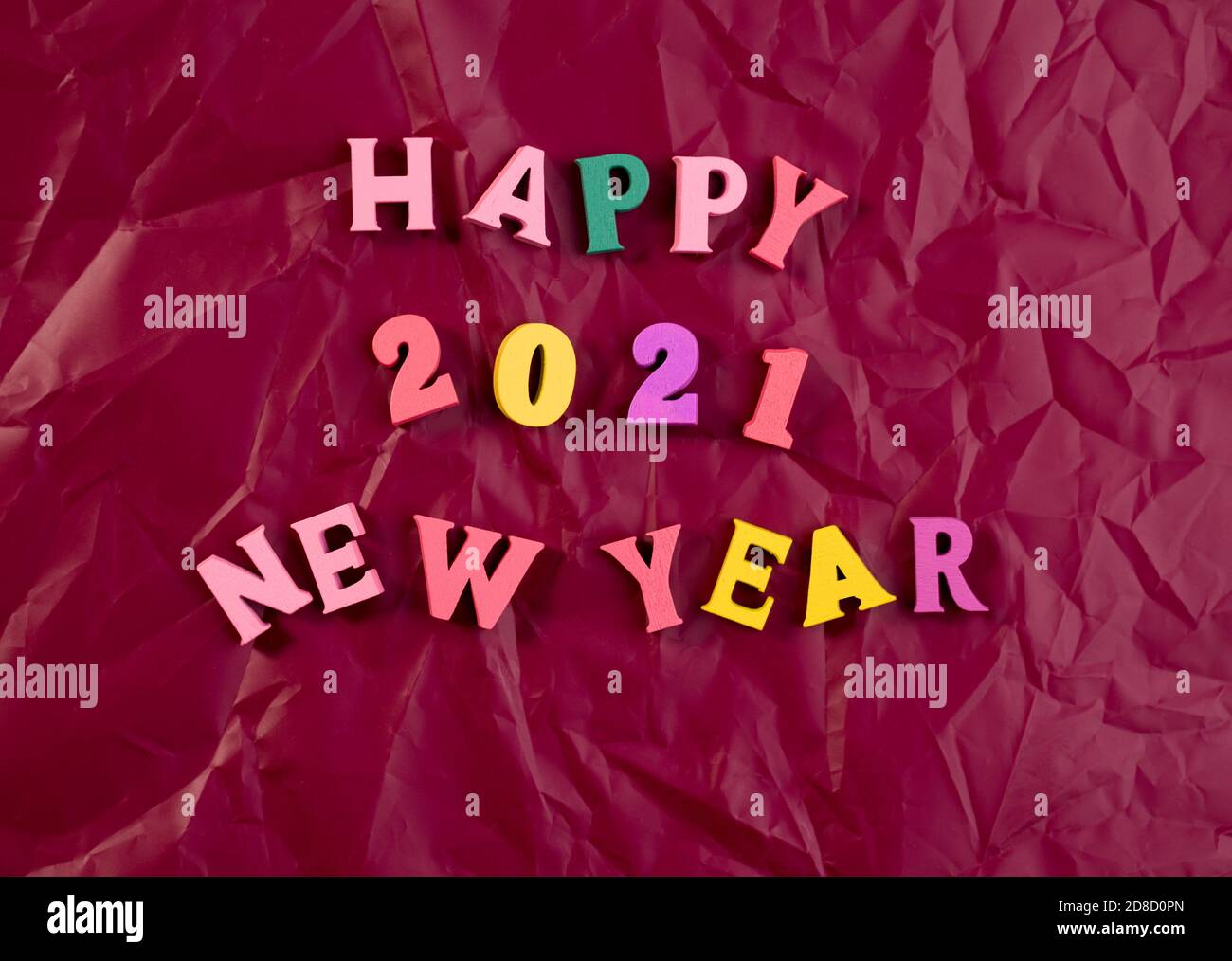 Happy New Year greeting words made of wooden letters, on a purple ...