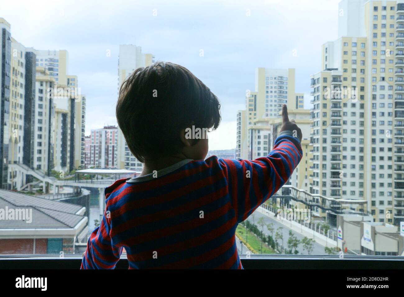 A child looks out at the garden from the balcony Stock Photo - Alamy