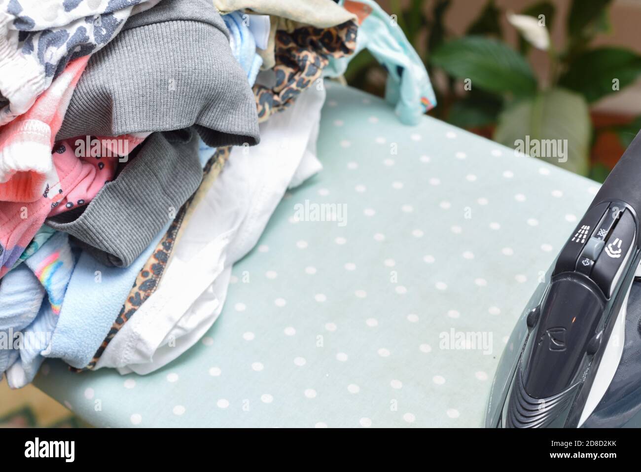 House work and chores at home Steam iron with a pile of clothes to be ...