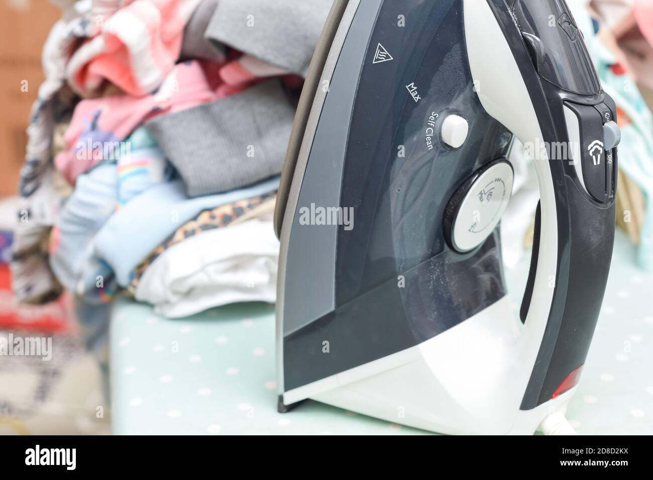 House work and chores at home Steam iron with a pile of clothes to be ...
