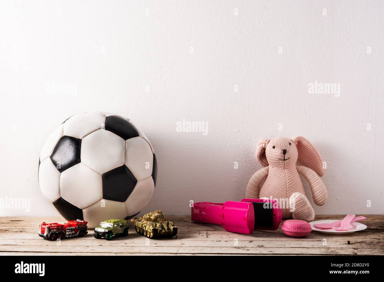 Gender stereotype toys on wooden table and white background Stock Photo ...