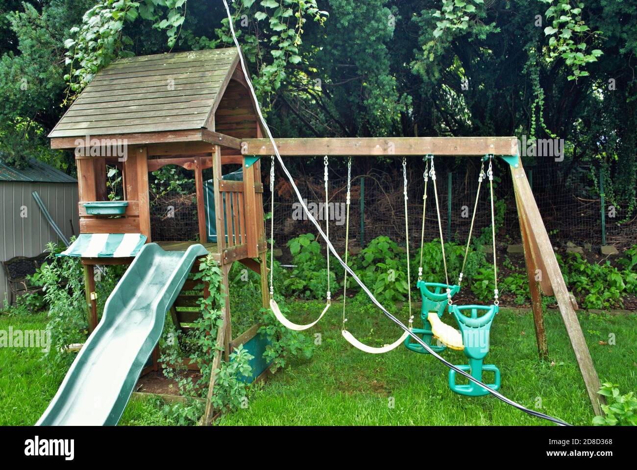 Dangerous live downed power line draped across backyard playground ...