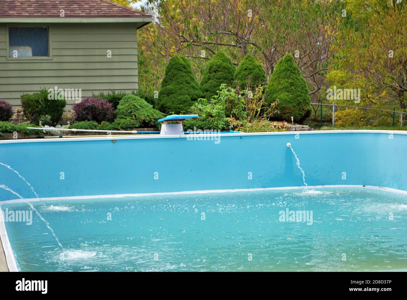 backyard swimming pool with diving board emptied out shutting down for ...