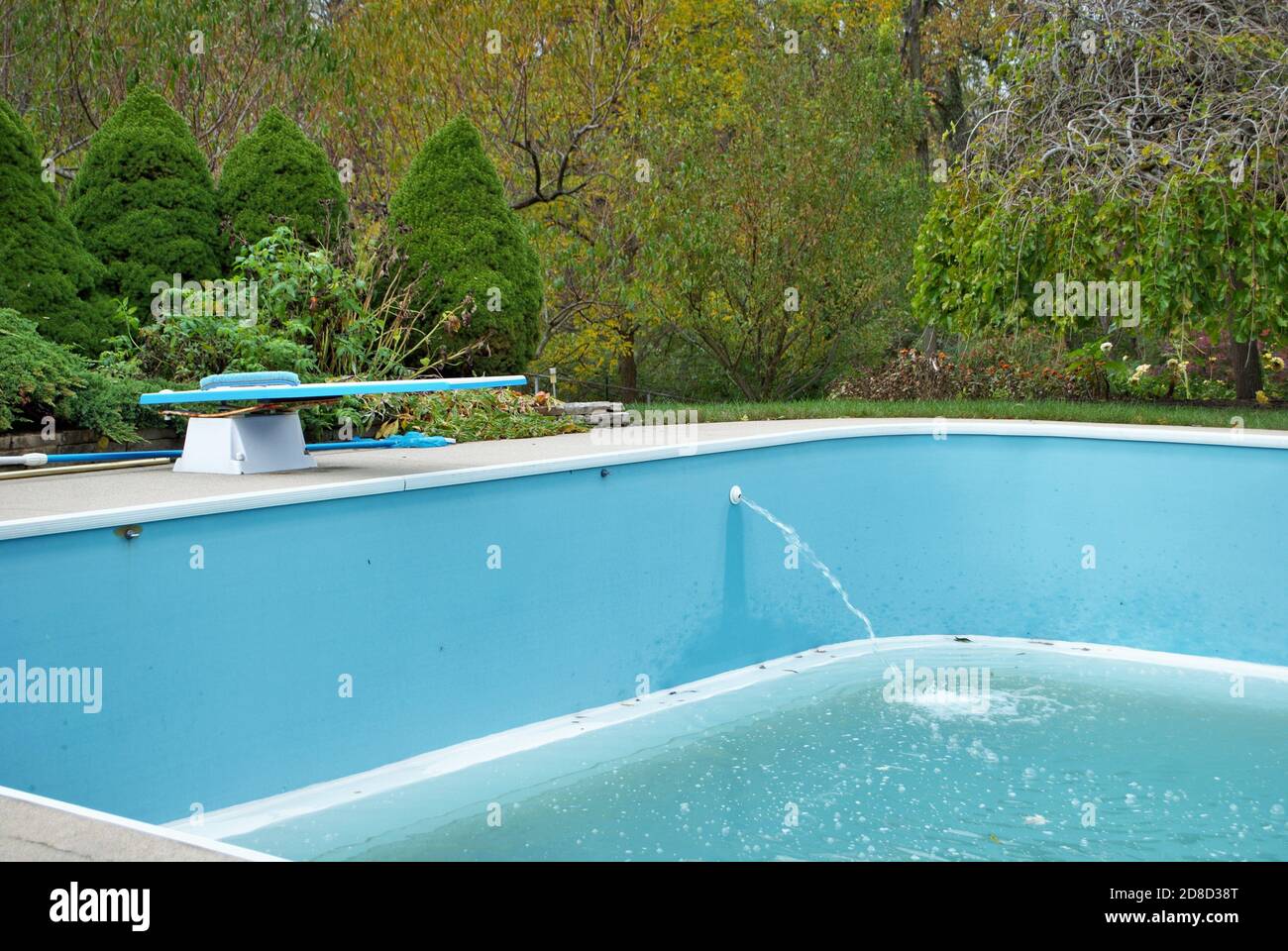 backyard swimming pool with diving board emptied out shutting down for ...