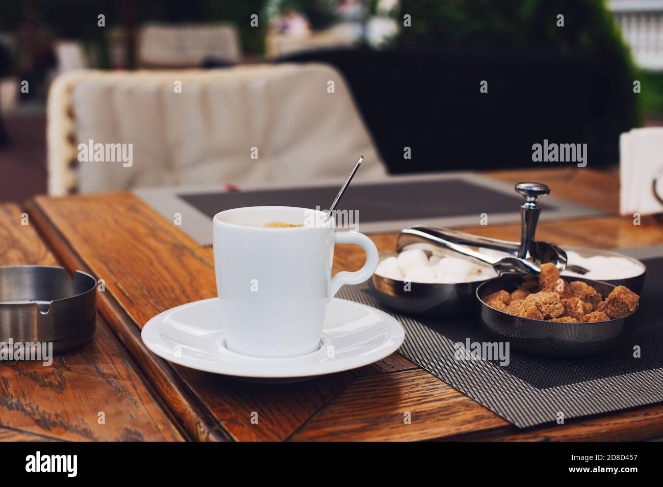 White coffee cup and a glass of water and sugar on a chic expensive ...