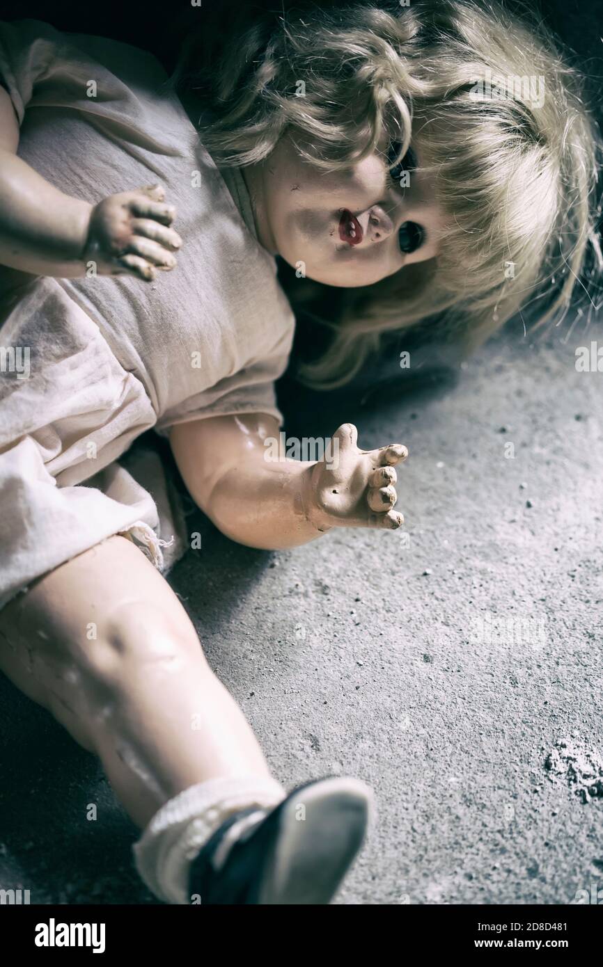 Doll lying on concrete Floor Stock Photo - Alamy