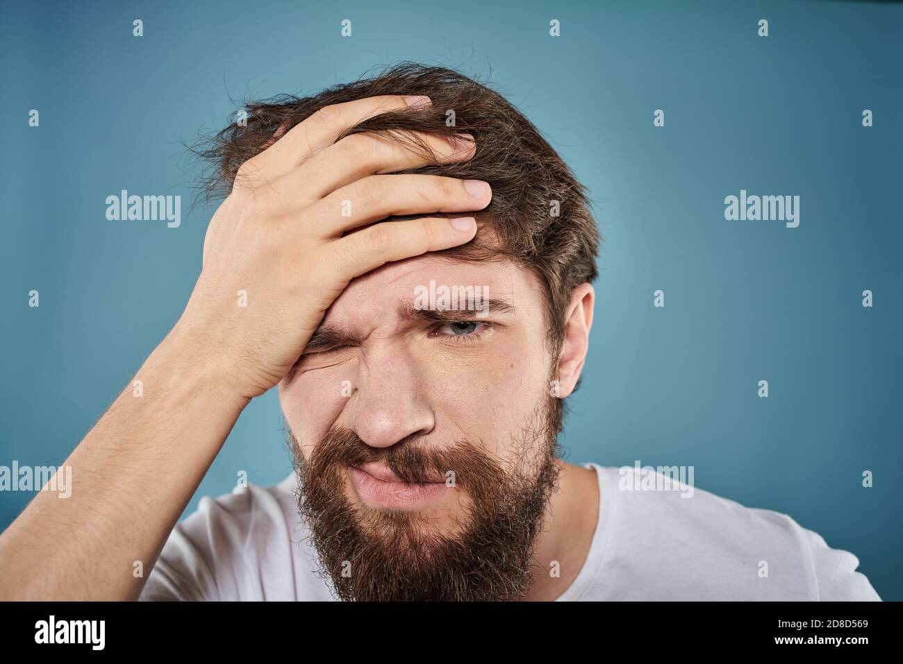 Bearded man displeased facial expression emotions close-up blue ...