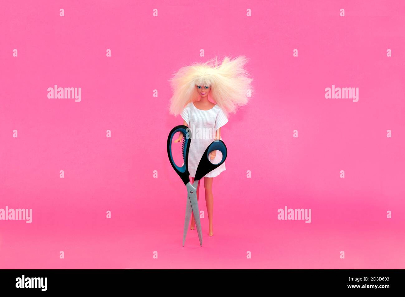 Ready for the haircut, Plastic female figure holding paper scissors ...