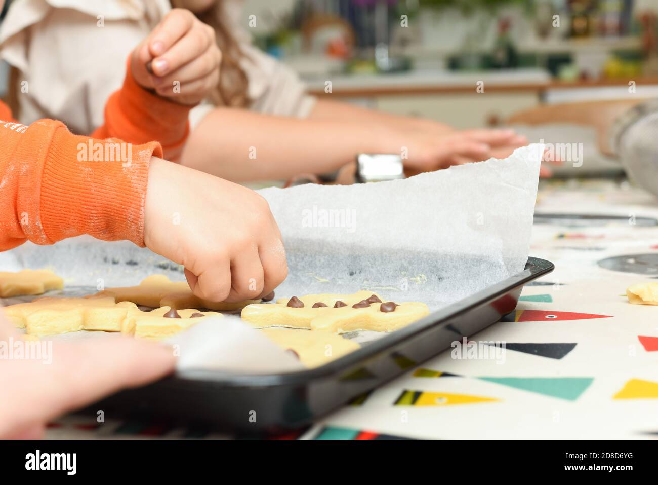 Kids are baking cookies in the kitchen the children are having fun ...
