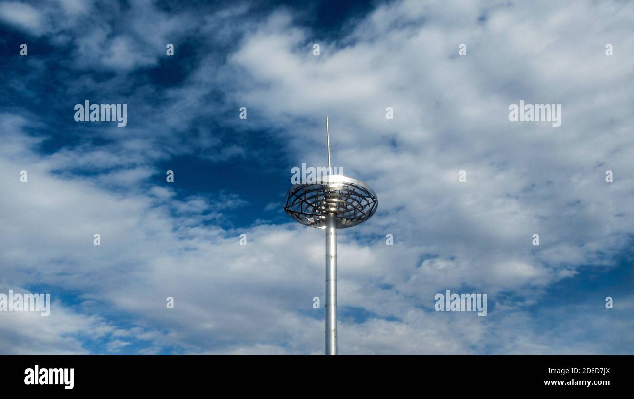 Unique bright metal light structure standing against blue sky Stock ...
